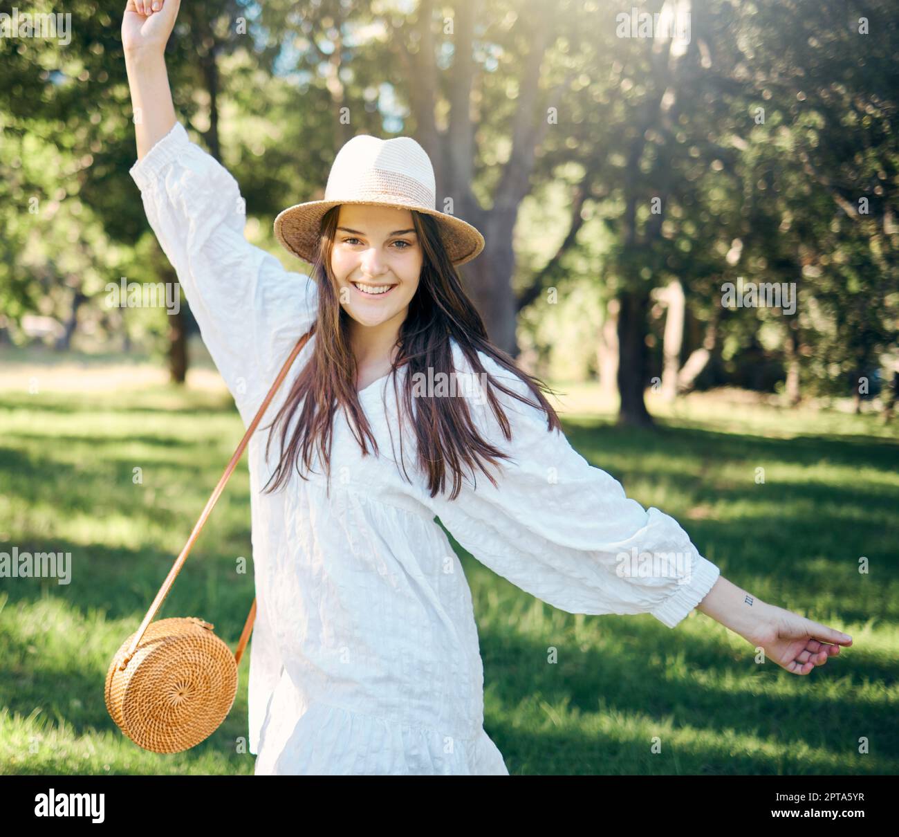 Happy woman in nature park dancing in summer with freedom, sunlight and ...