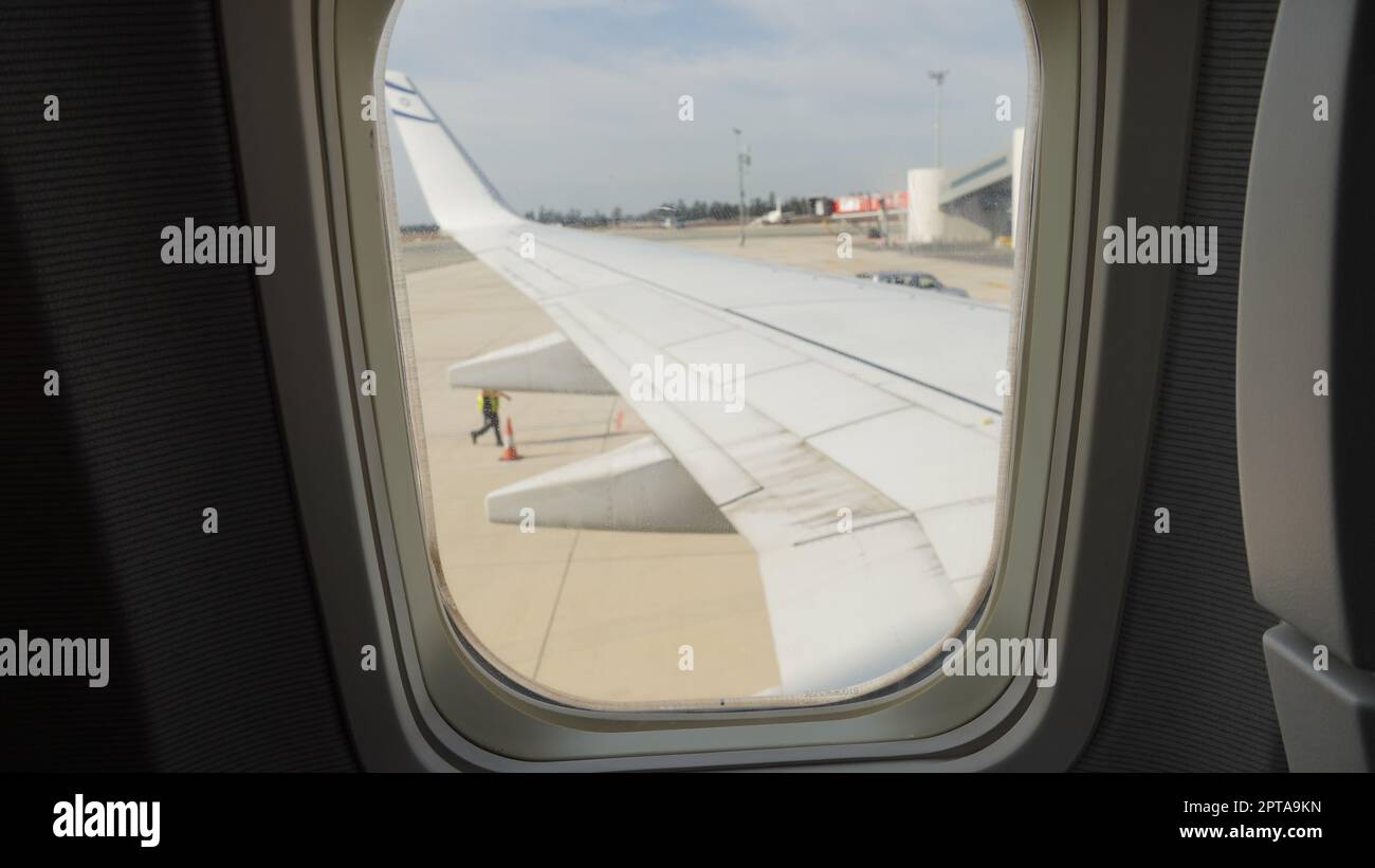 Wing of an airplane, passenger s view. Looking through the window of a ...