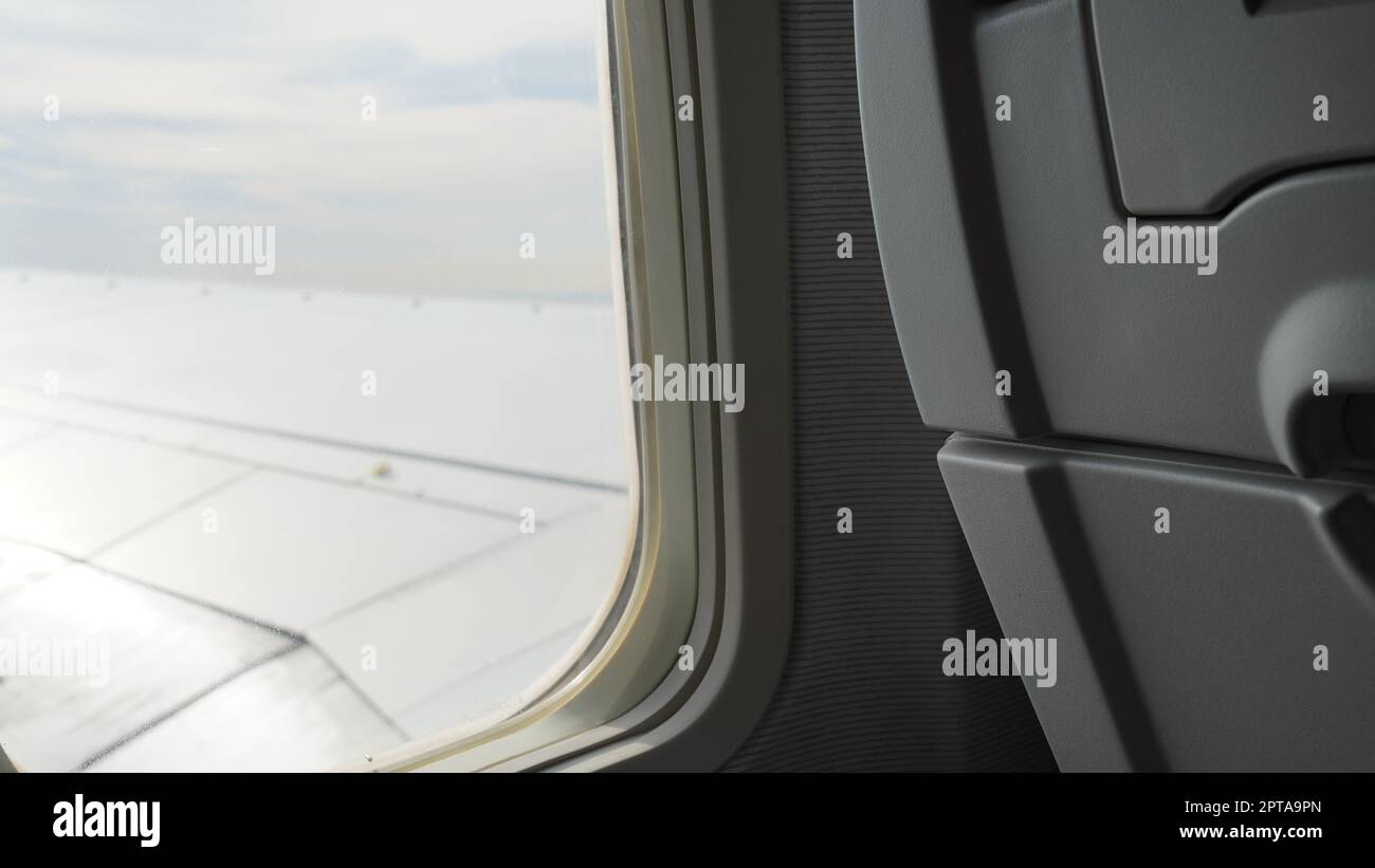 Wing of an airplane, passenger s view. Looking through the window of a ...