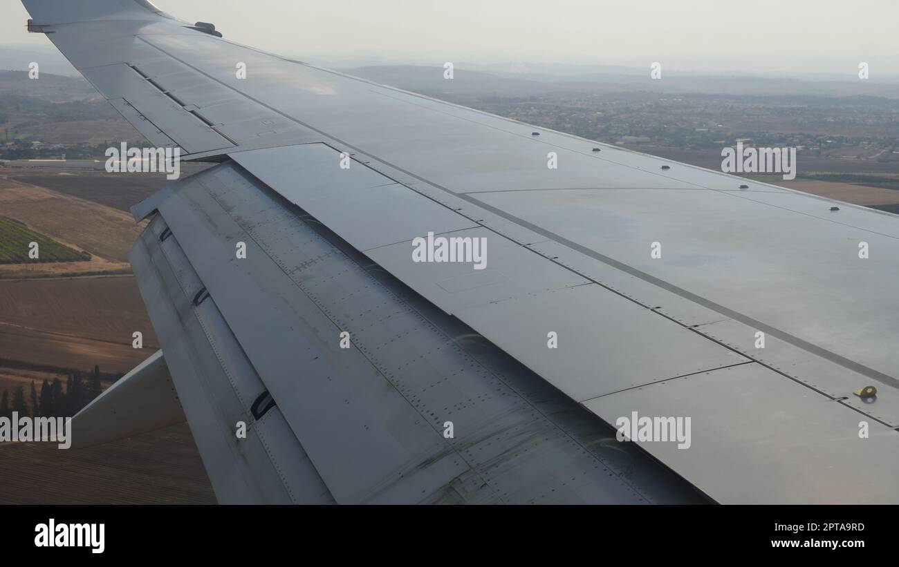 Wing of an airplane flying over Israel, Passenger s view. Looking ...
