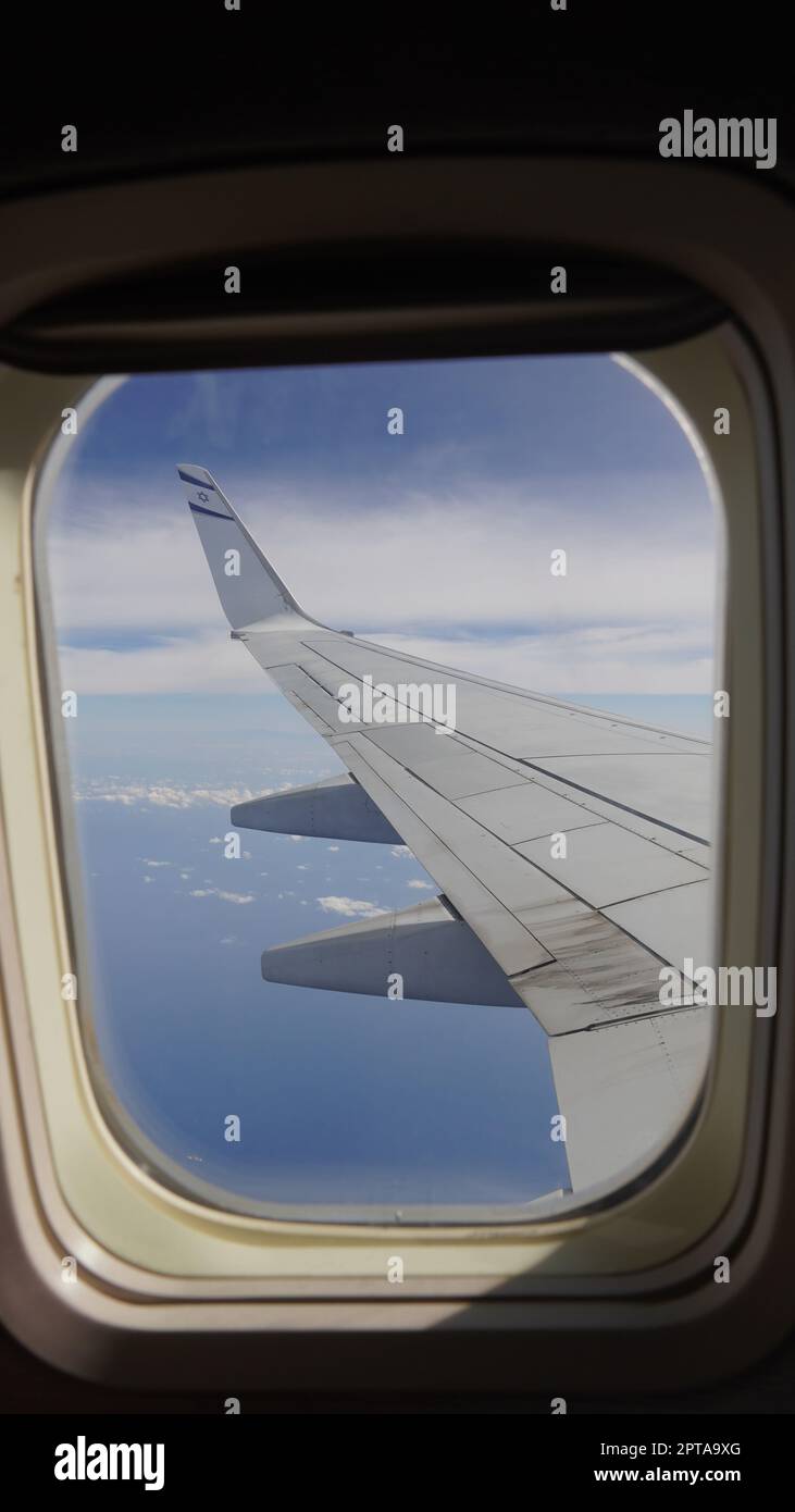 Wing of an airplane, passenger s view. Looking through the window of a ...