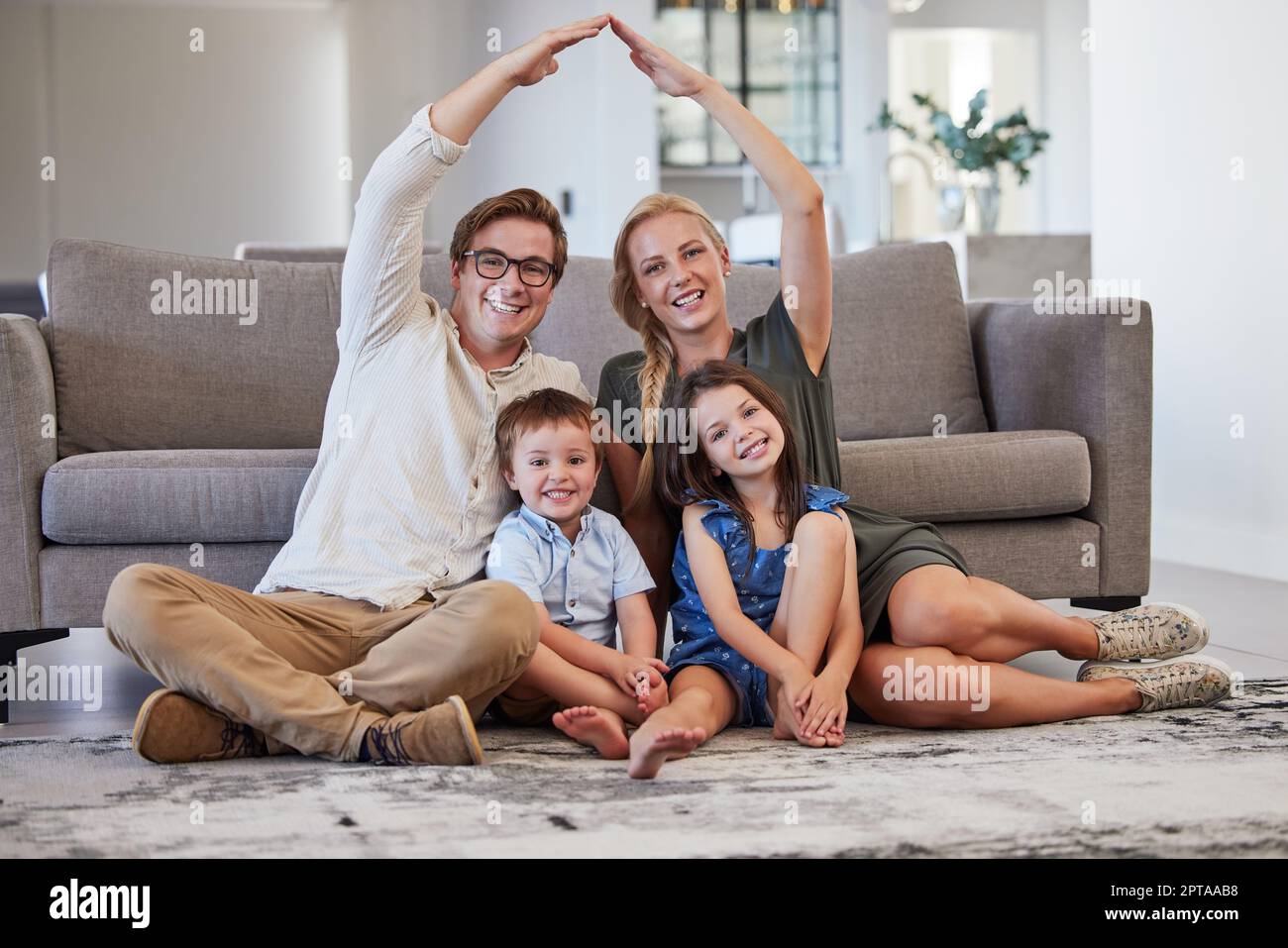 Family home with parents, kids and roof sign for real estate, moving ...