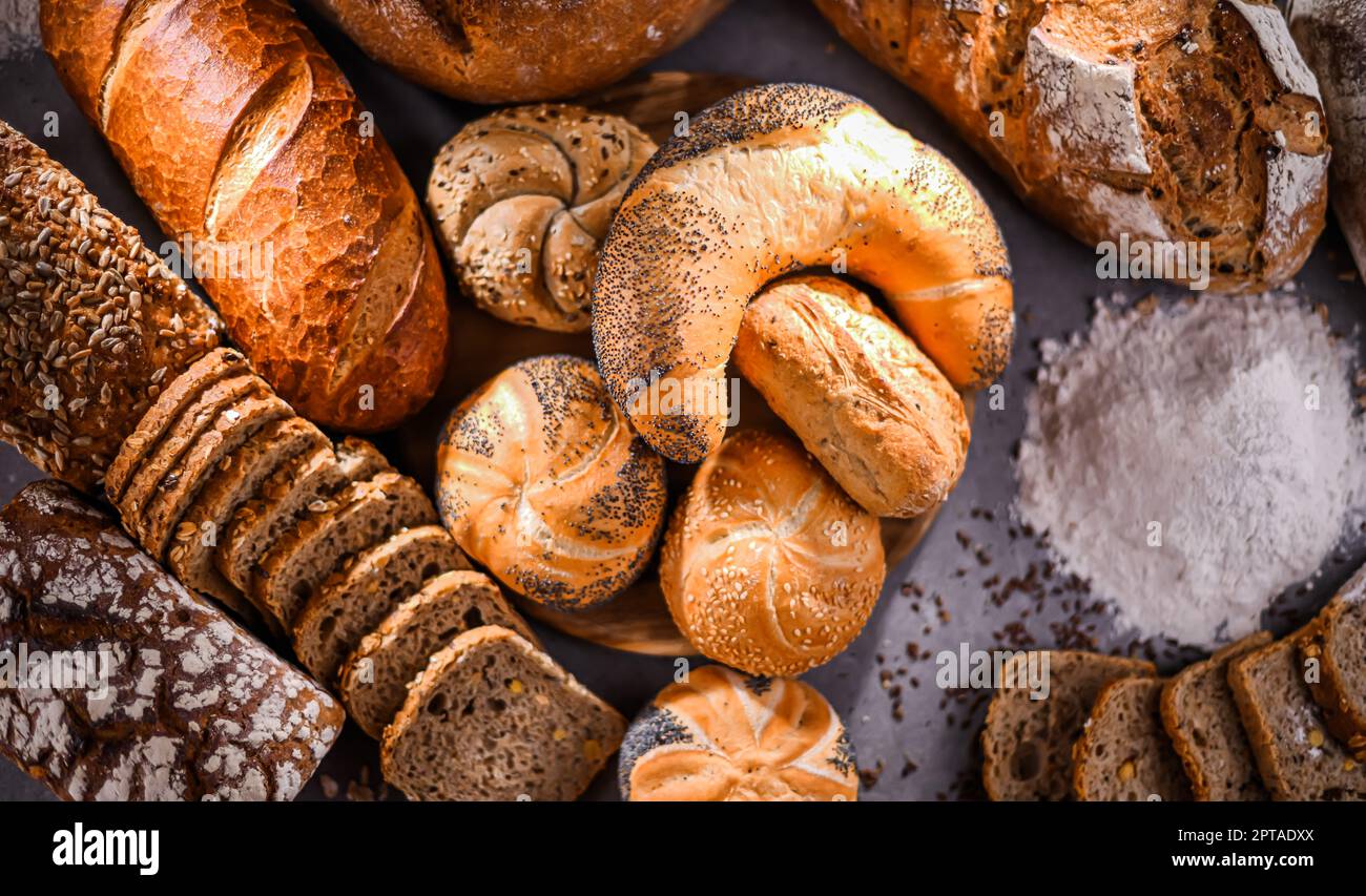 Assorted bakery products including loafs of bread and rolls Stock Photo ...
