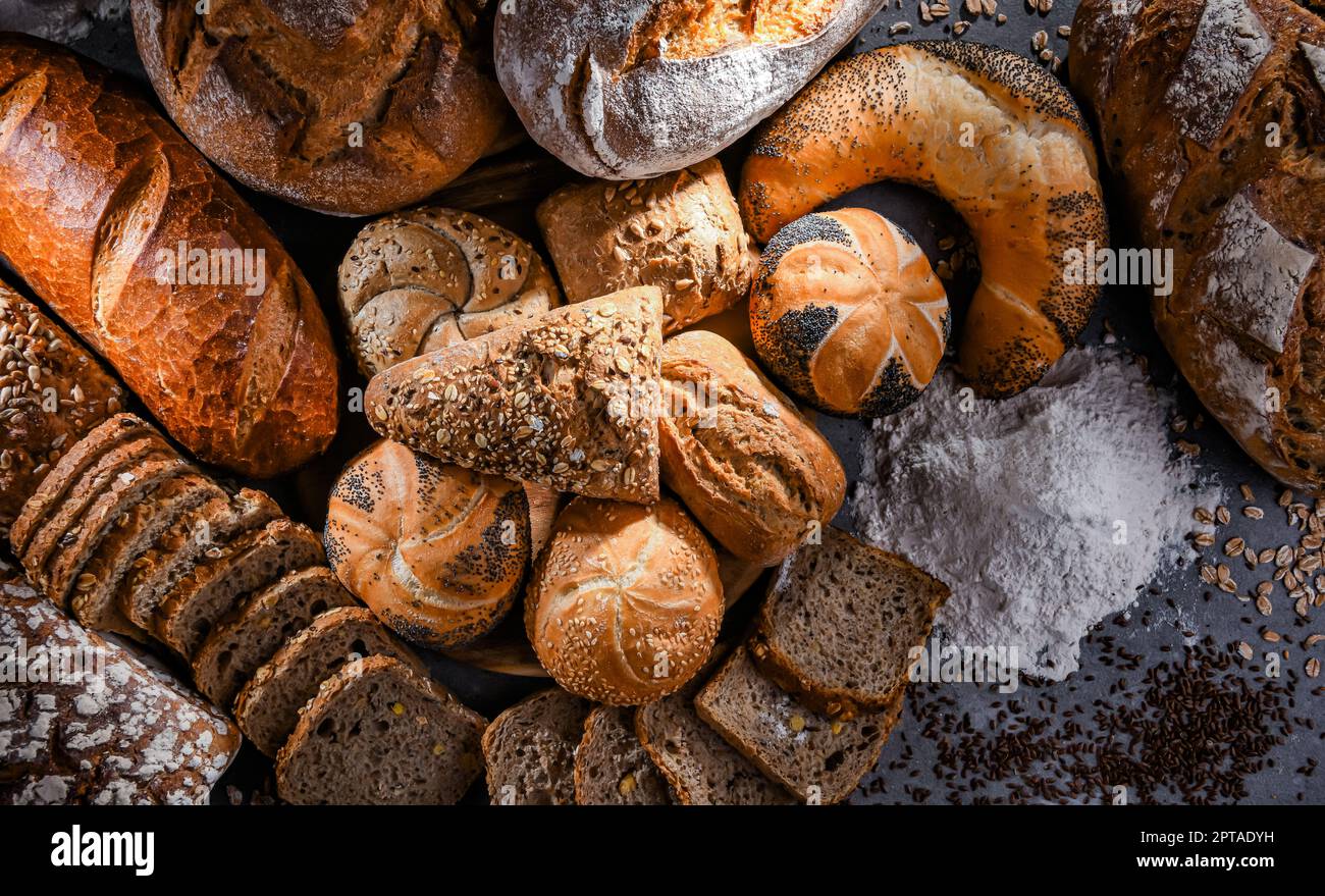 Assorted bakery products including loafs of bread and rolls Stock Photo ...