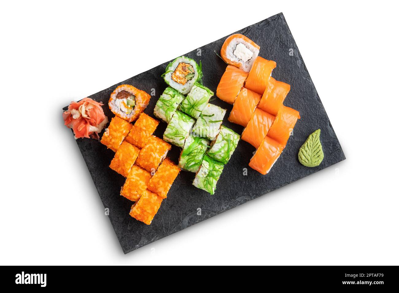 Set of rolls with wasabi and pickled ginger on stone serving board ...