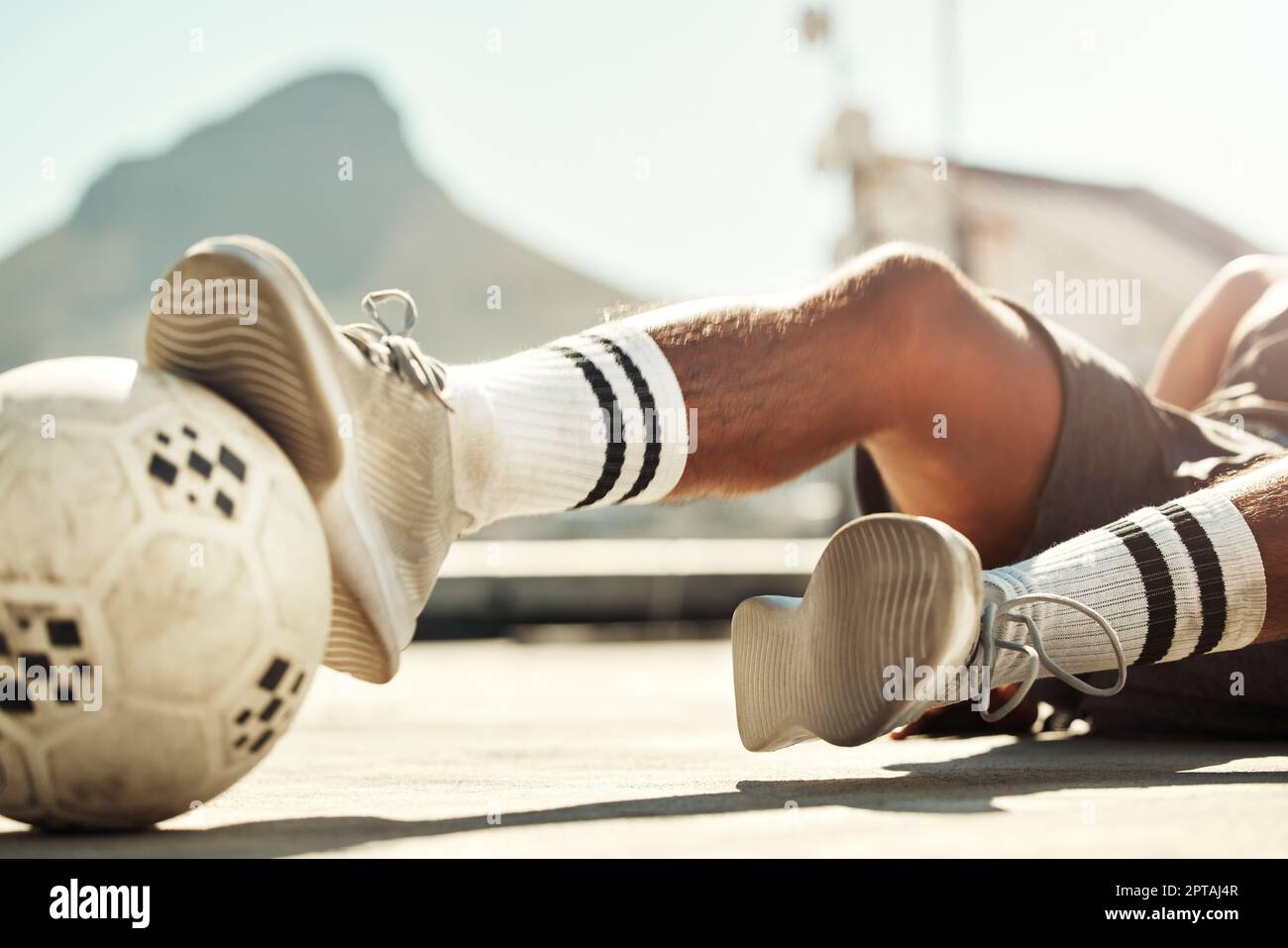 Soccer, ball and man with slide challenge during match, practice or ...
