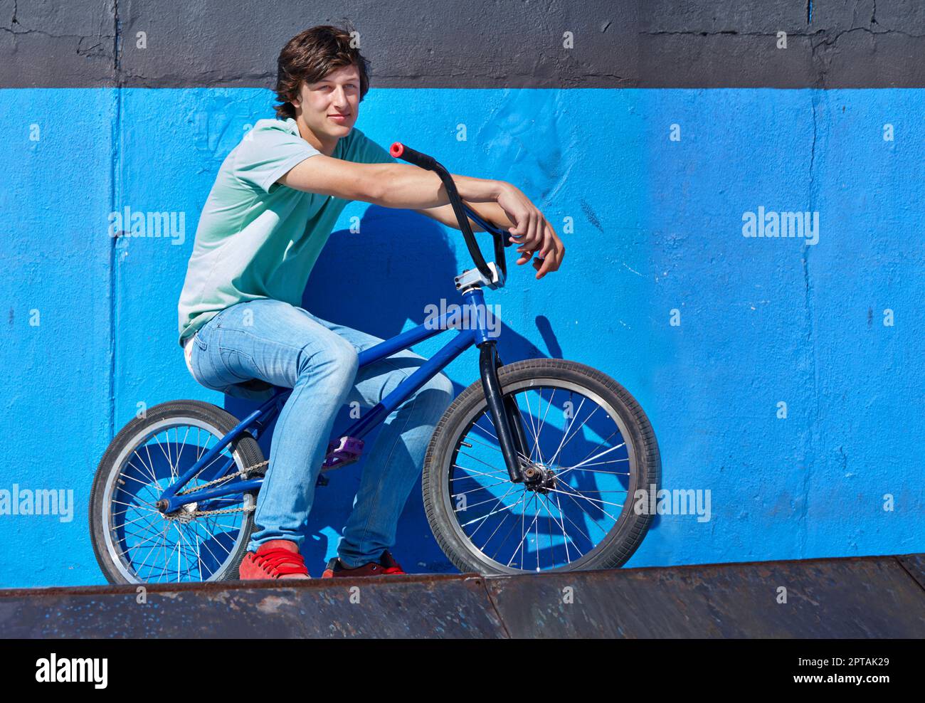 Practicing for the x games. Full length shot of a teenage boy riding a ...