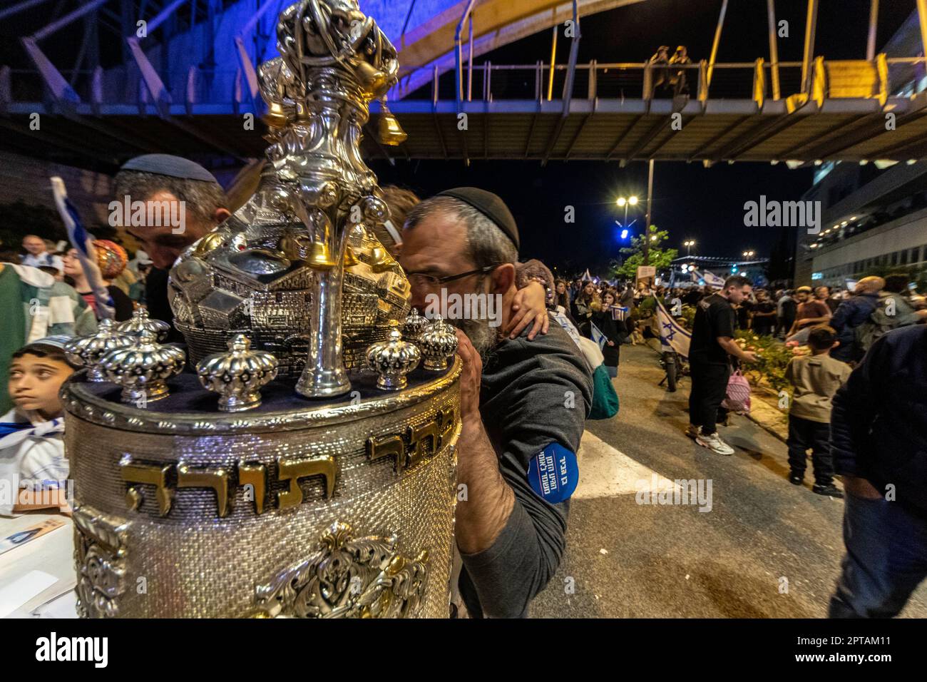 Israel. People with Israeli flags kiss an ornate Torah scroll ...