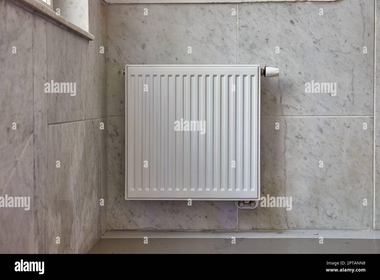 Heating radiator mounted on the wall of a public building Stock Photo ...