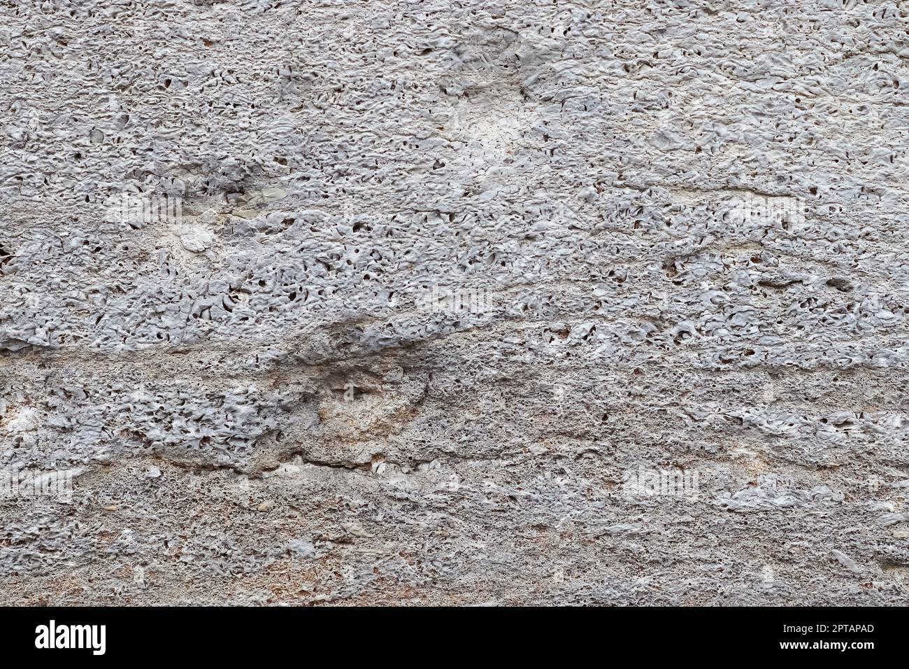 Aged concrete wall of historical building with cracks and a lot of ...