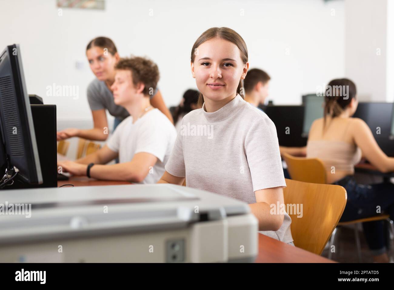 Portrait of smiling girl student looking at camera during lesson in ...