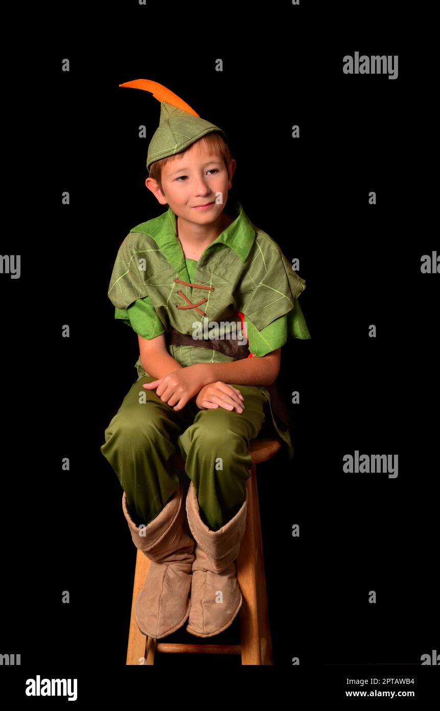 Young boy dressed as Peter Pan sitting on a stool Stock Photo - Alamy