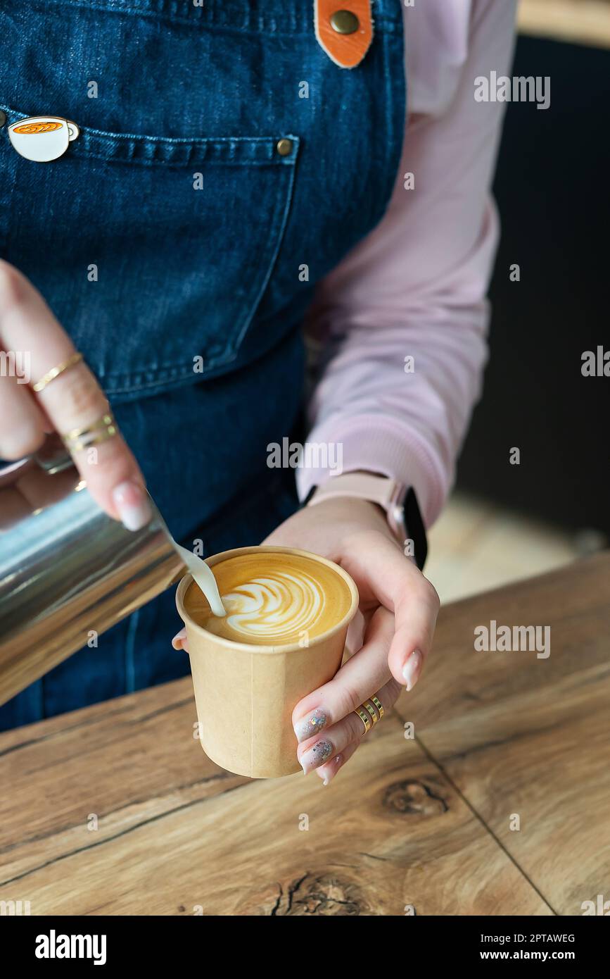 The process of making a barista cappuccino with a beautiful pattern on ...