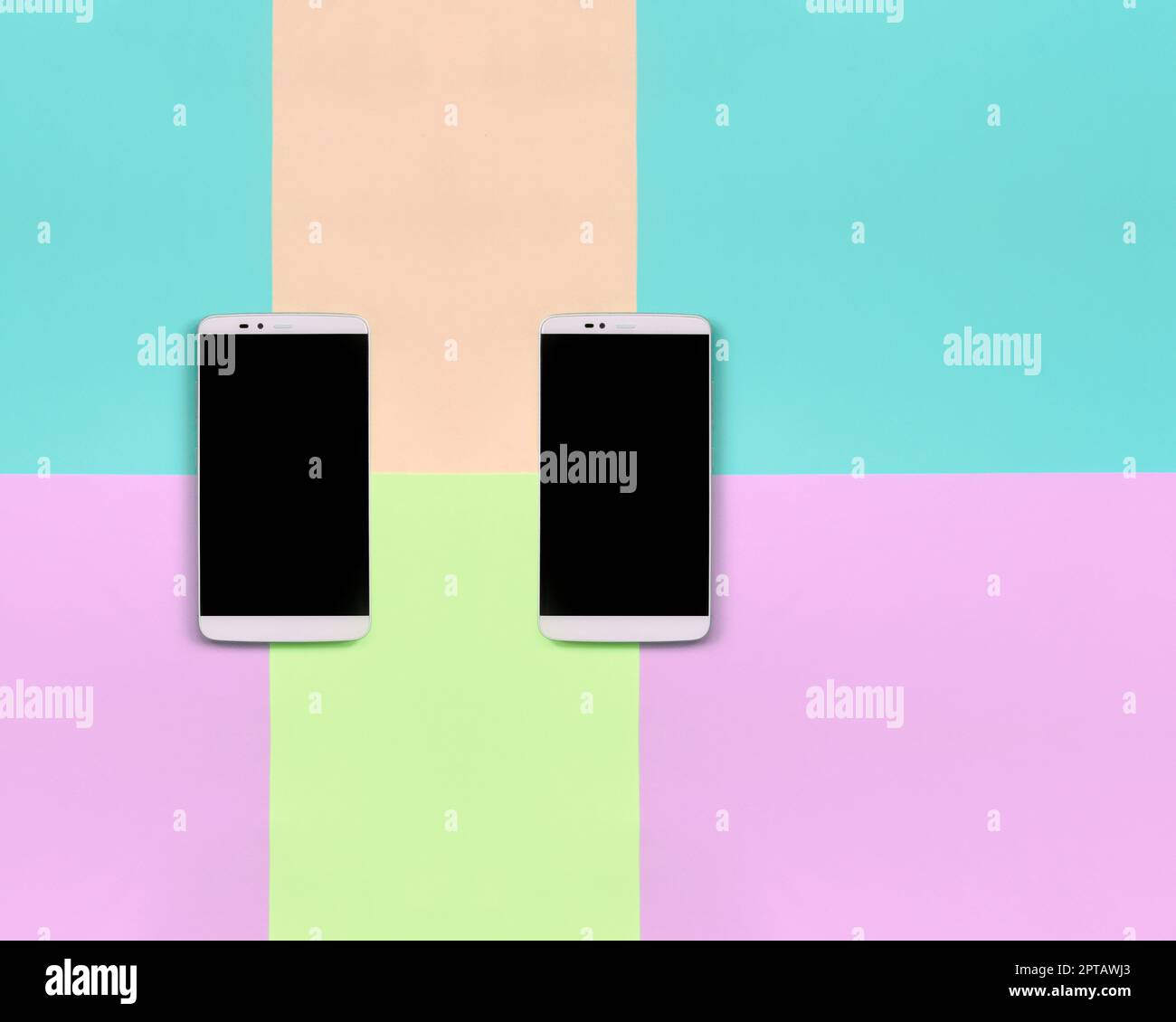 Two modern smartphones with black screens on texture background of ...