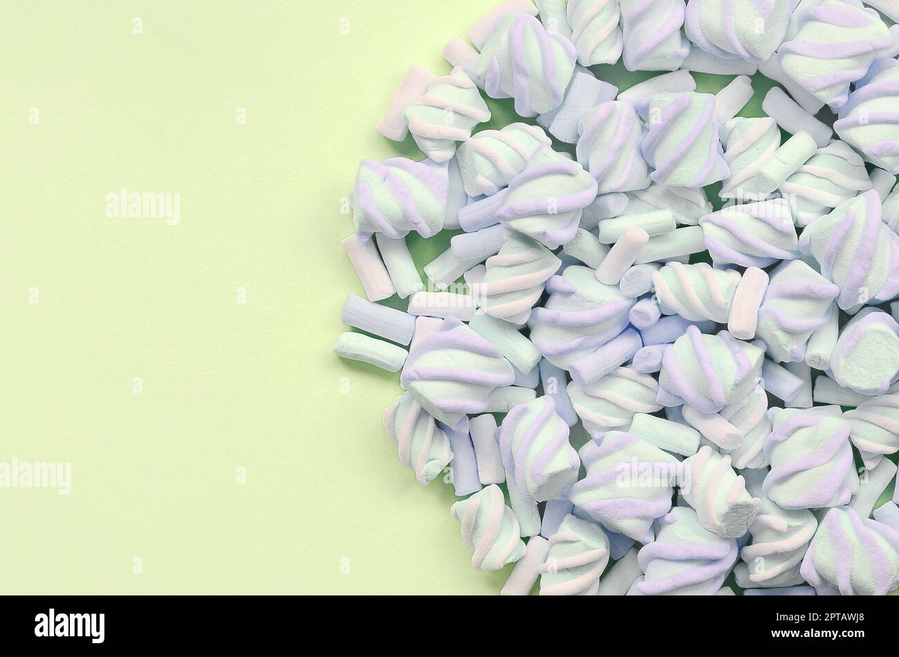 Colorful marshmallow laid out on lime paper background. pastel creative ...