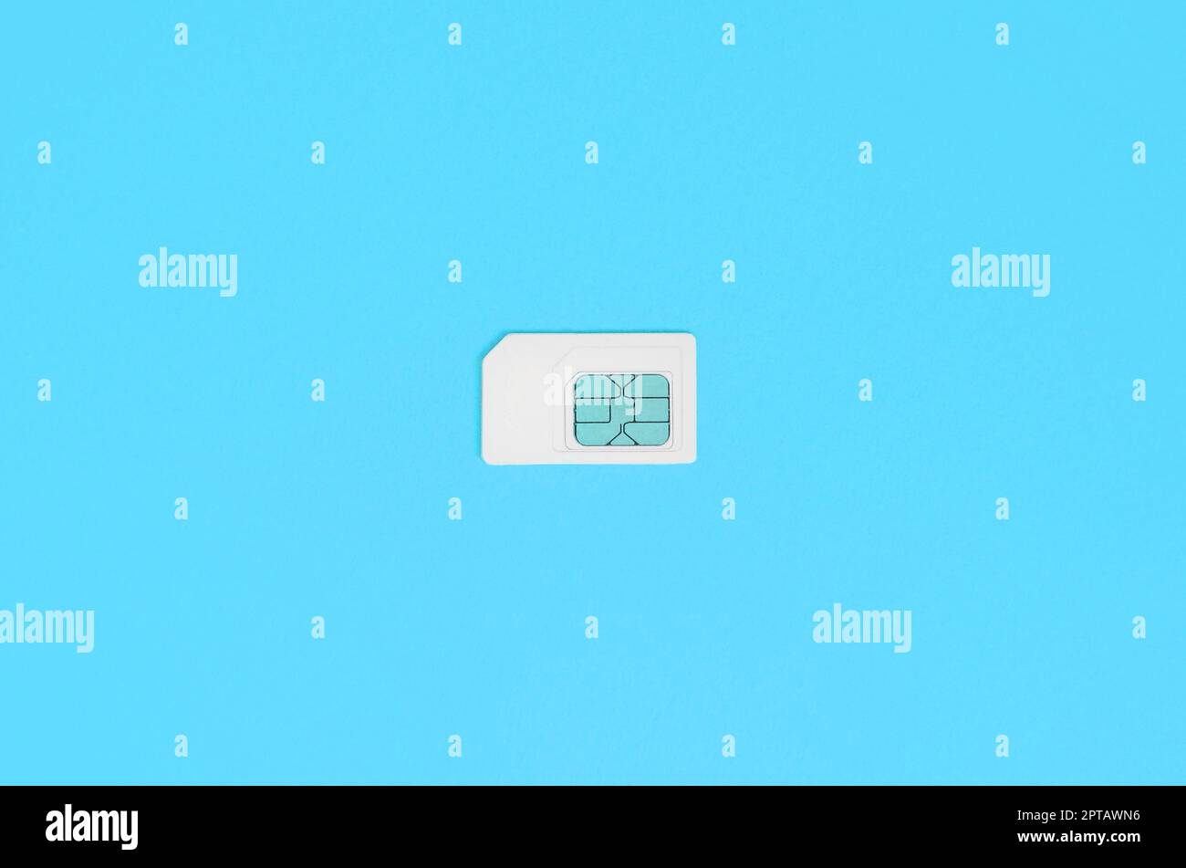 Subscriber identity module. New white SIM card on bright blue color ...