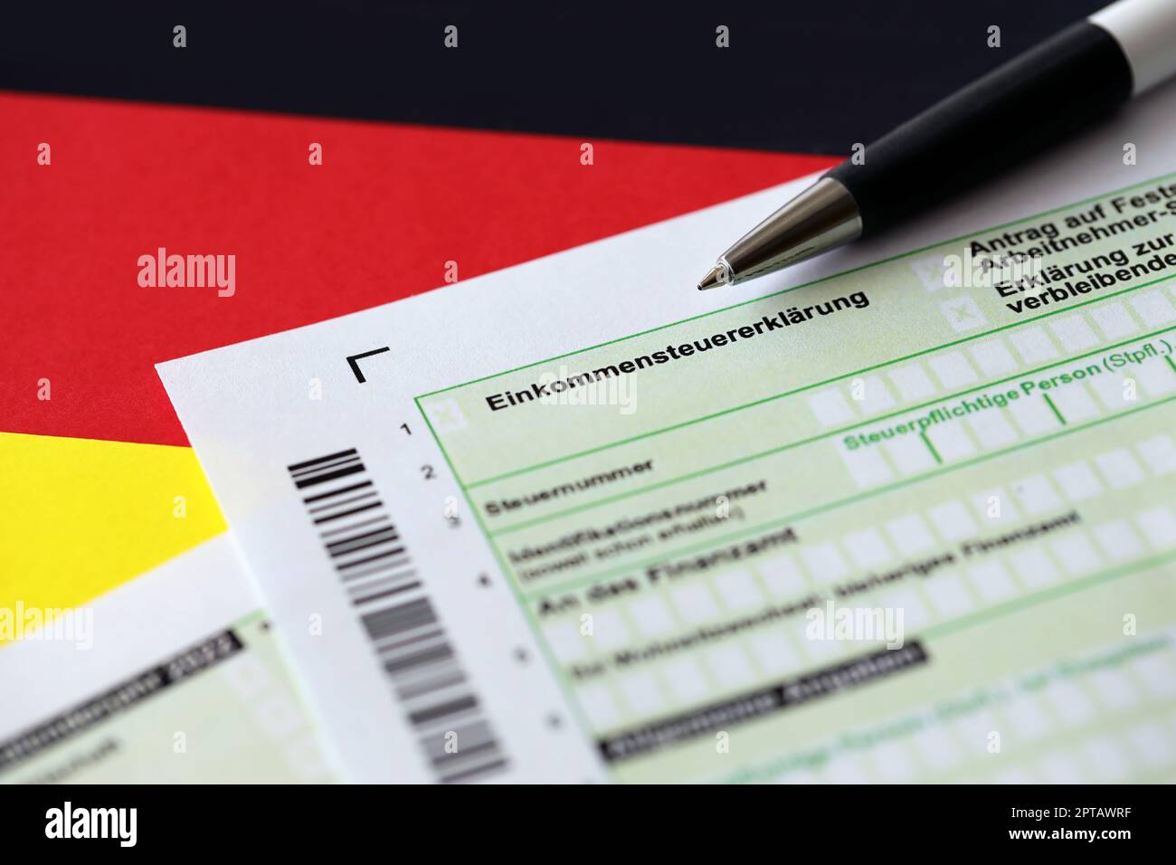 German annual income tax return declaration form with pen on flag close ...