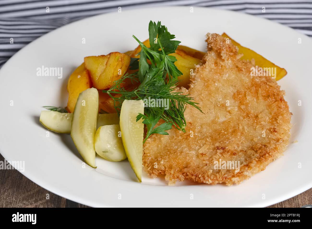 Chicken entrecote with potato and salty cucumber Stock Photo - Alamy