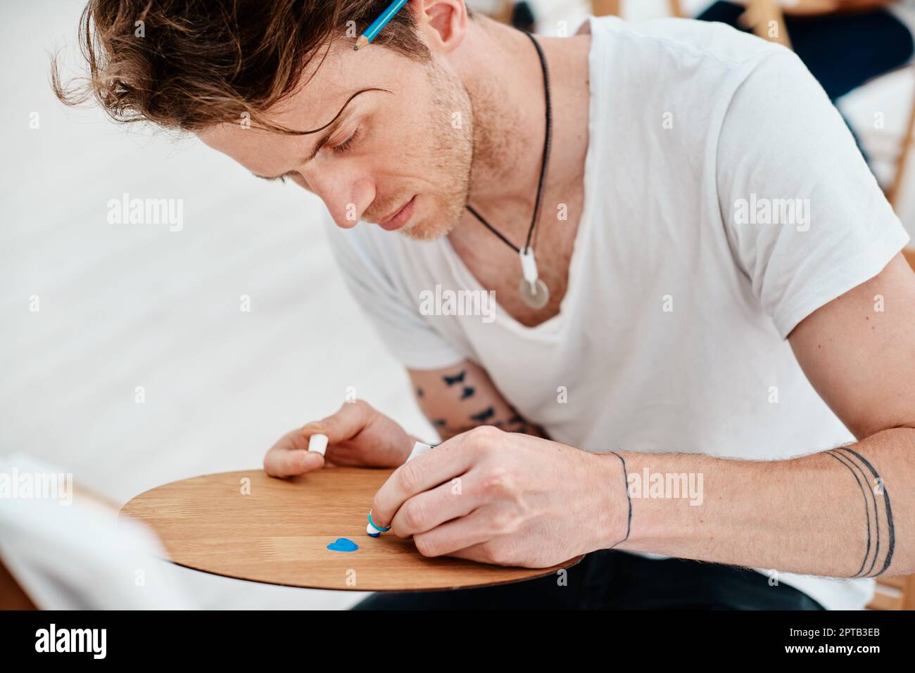 Art is what you make others see. a handsome young artist squeezing ...