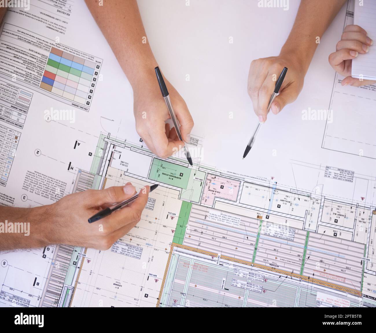 Planning out the fine details. Aerial view of a group of architects ...
