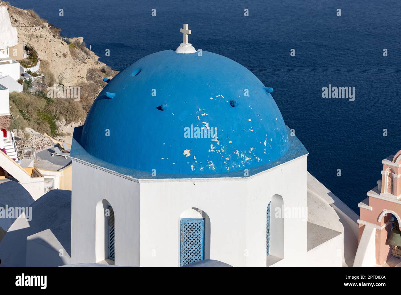 View from viewpoint of Oia village with blue dome of greek orthodox ...