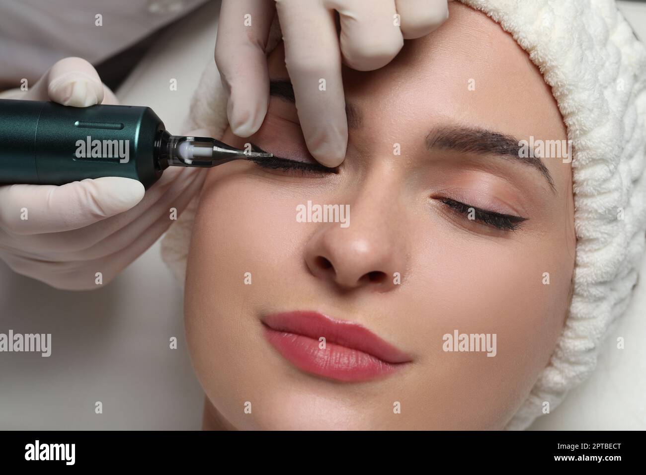 Young woman undergoing procedure of permanent eye makeup, closeup Stock ...