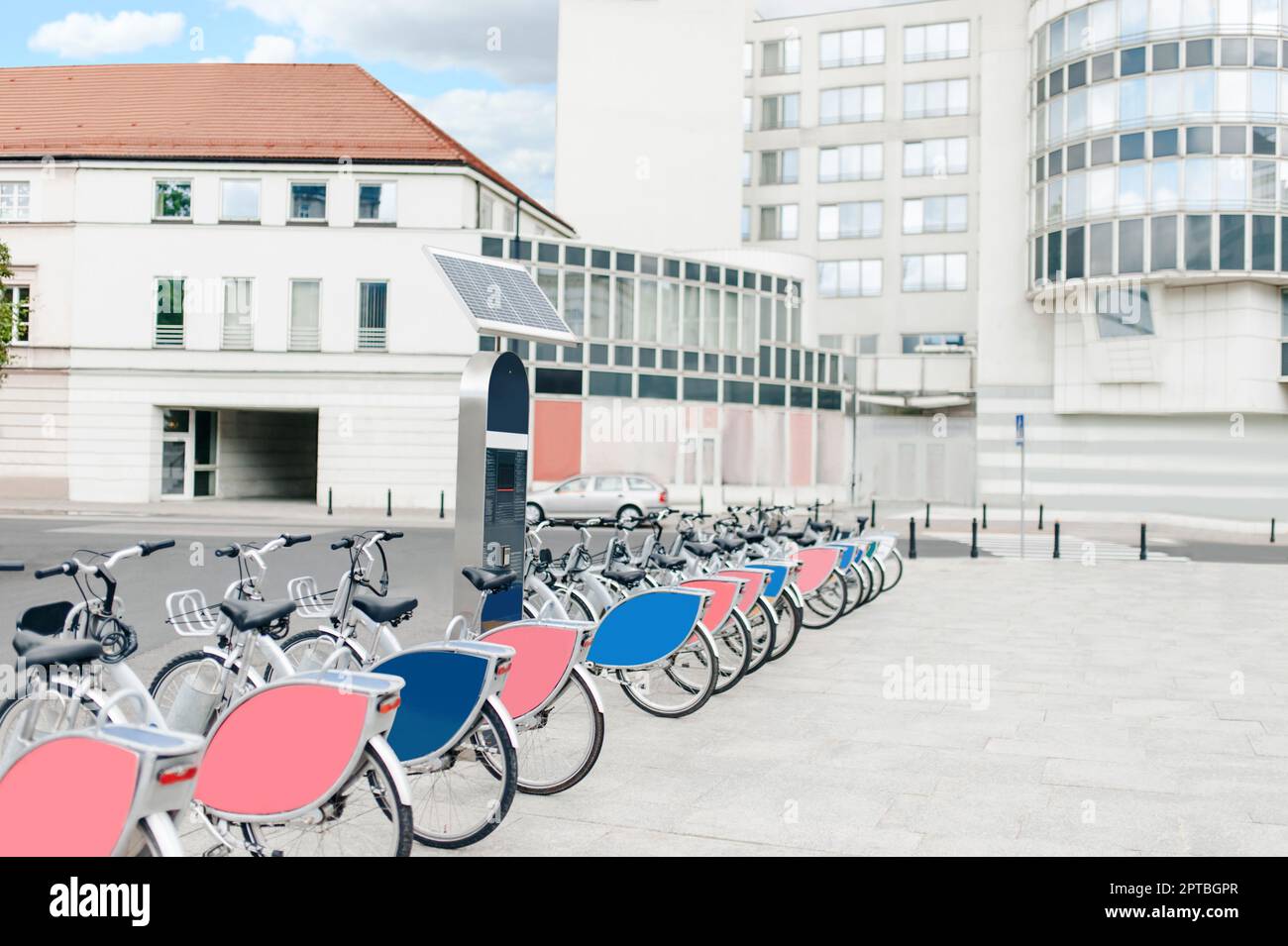 Many bicycles and station on city street. Bike rental fleet Stock Photo ...