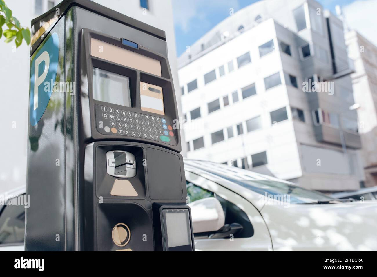 Modern parking meter on city street, low angle view. Space for text ...
