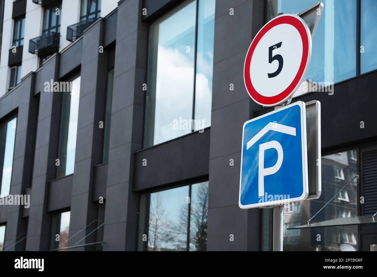 Traffic signs Parking and Speed Limit near modern building Stock Photo ...