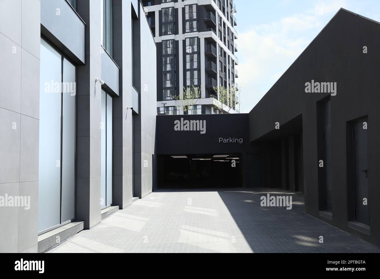 Parking garage with metal gate in modern building Stock Photo - Alamy