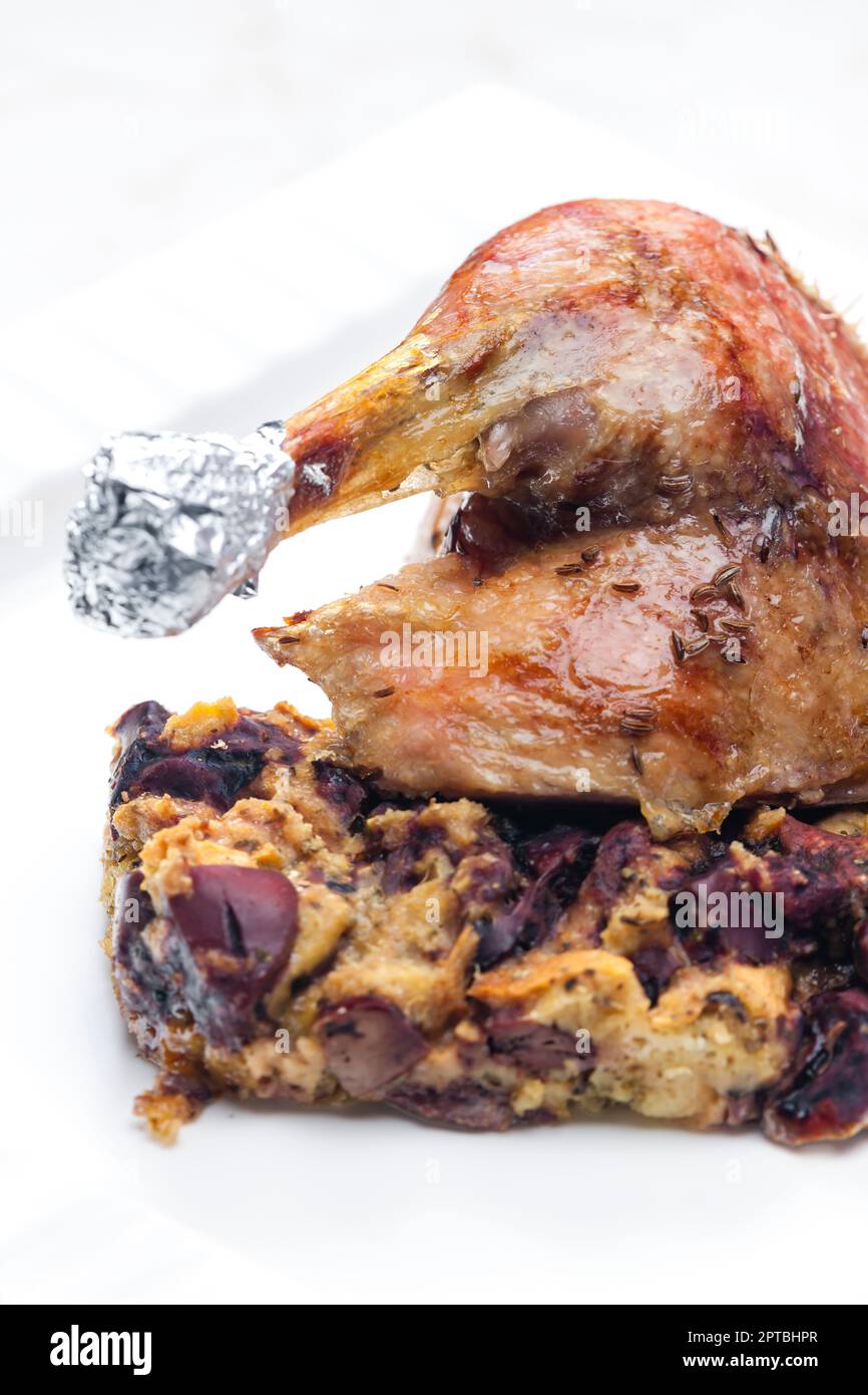bake poultry leg served with stuffing with red beans Stock Photo - Alamy