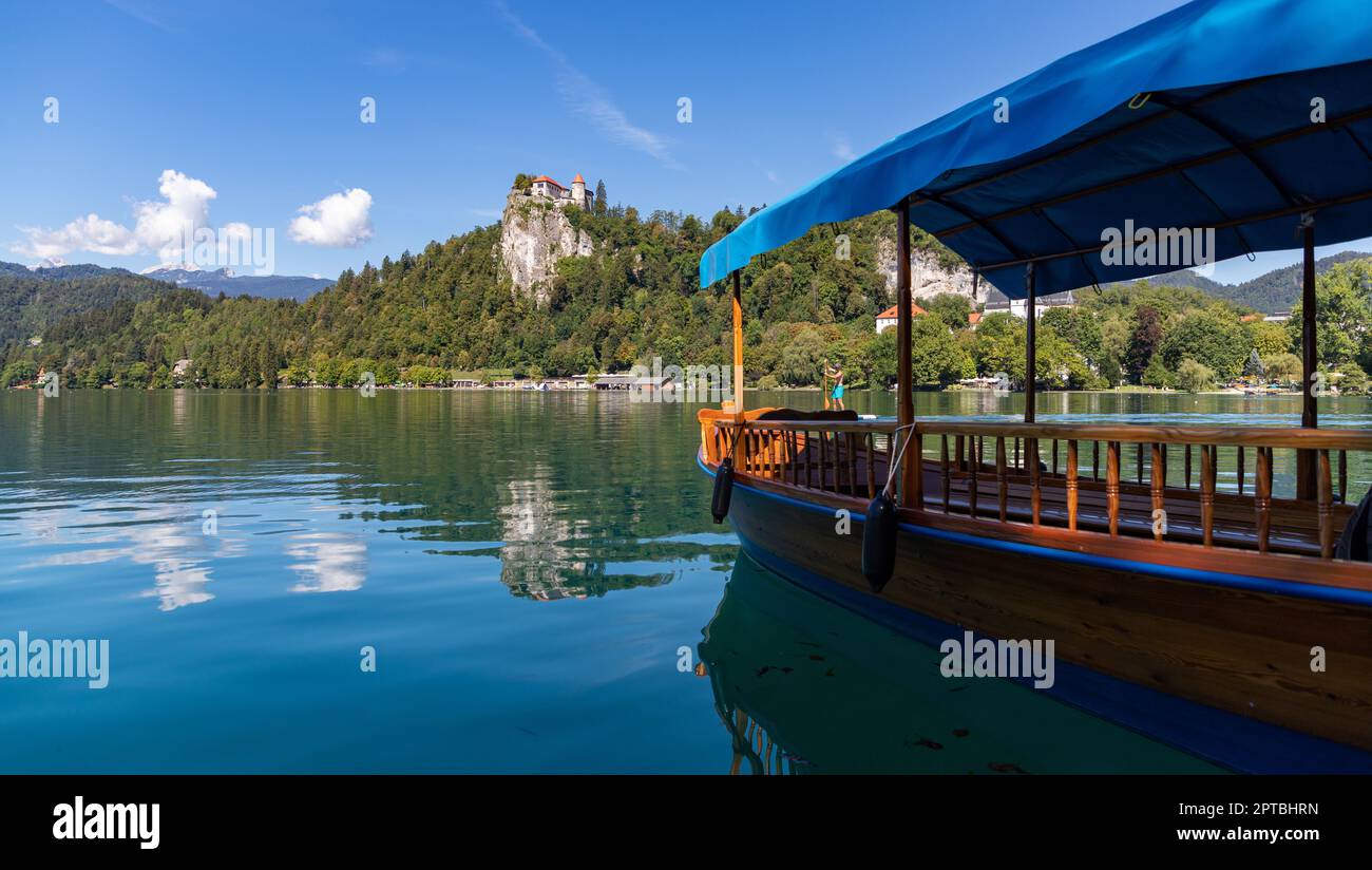 A picture of one of Lake Bled's gondolas, named "pletna", overlooking ...