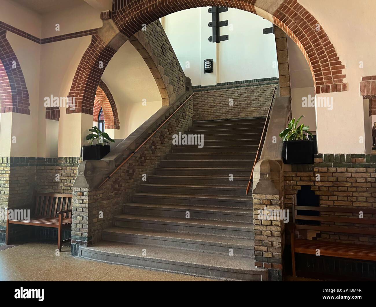 School hallway interior with arch above stone staircase Stock Photo - Alamy