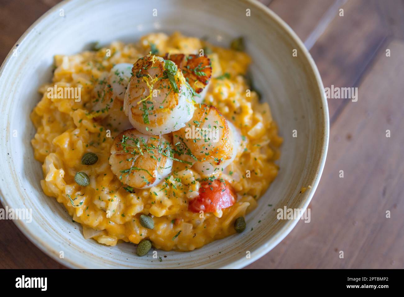 Scallop risotto dish in restaurant Stock Photo - Alamy
