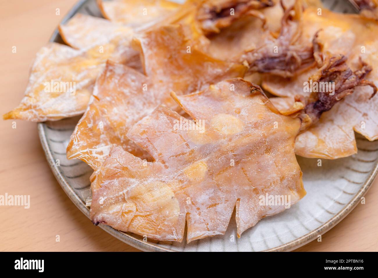 Dried whole squid snack in the plate Stock Photo - Alamy
