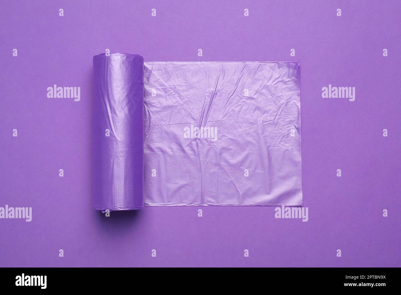 Roll of color garbage bags on violet background, top view Stock Photo ...