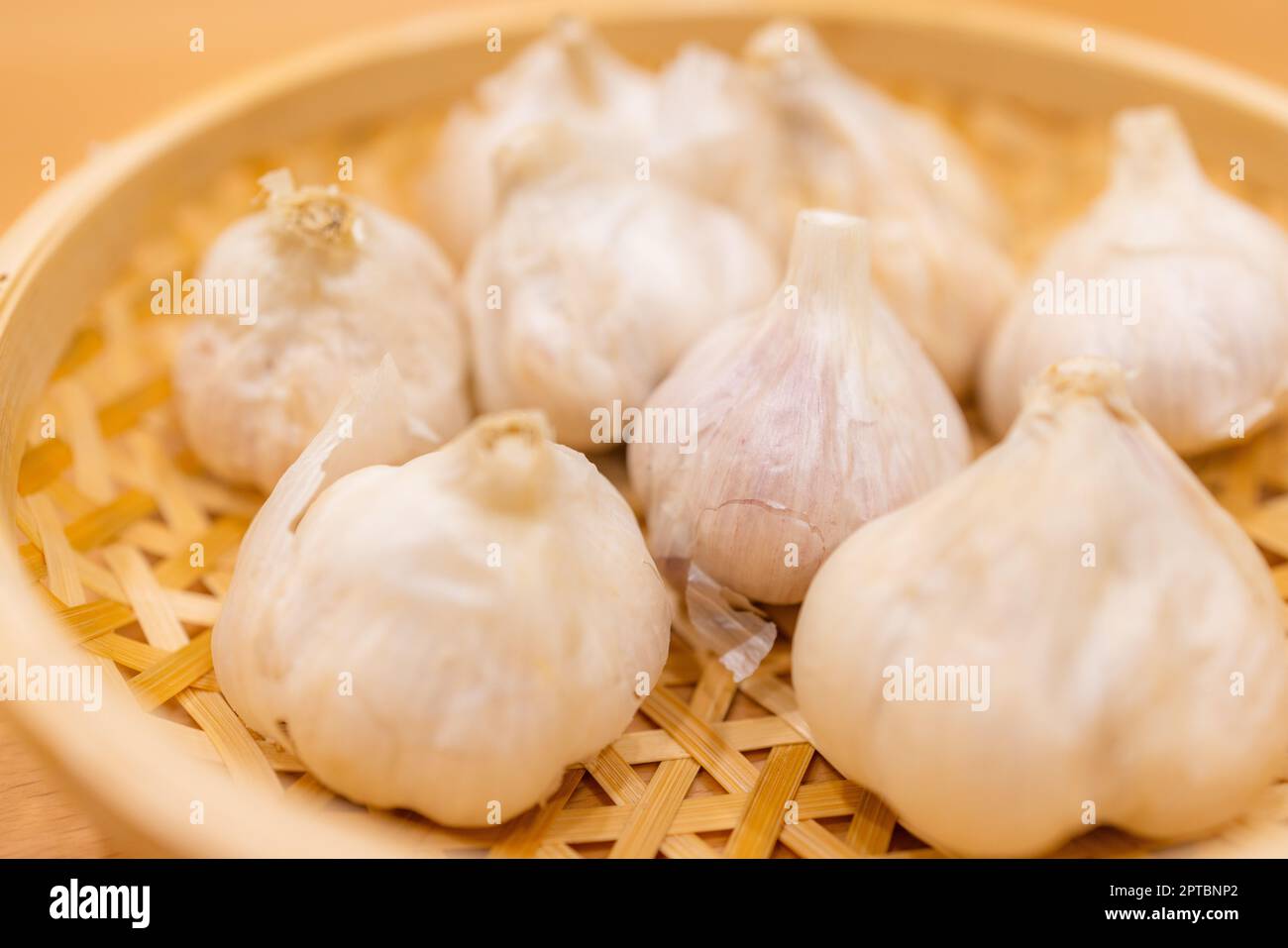 Stack of garlic on basket Stock Photo - Alamy