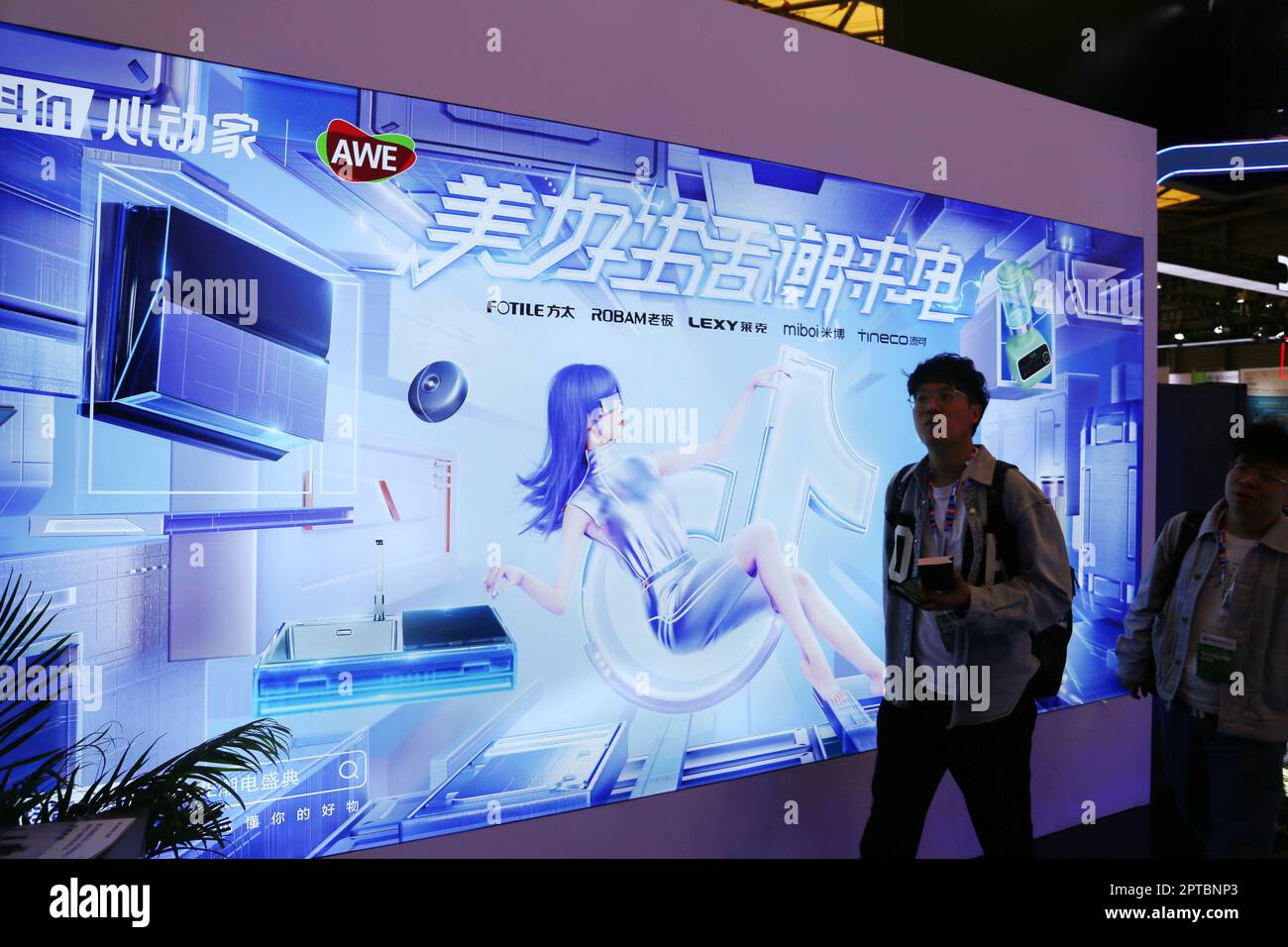 SHANGHAI, CHINA - APRIL 27, 2023 - Visitors pass a poster at the AWE2023 exhibition in Shanghai ...
