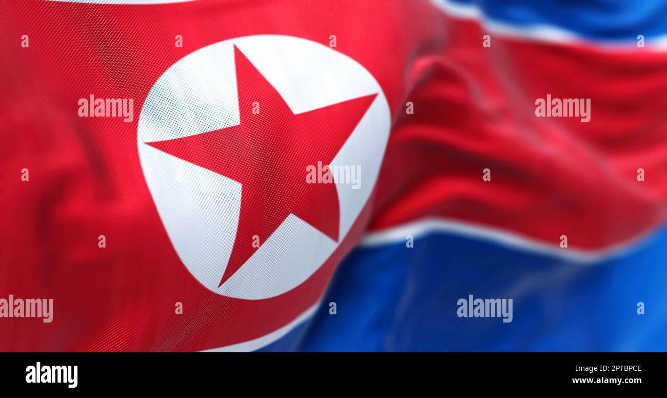 Close-up view of the North Korea national flag waving in the wind. The ...