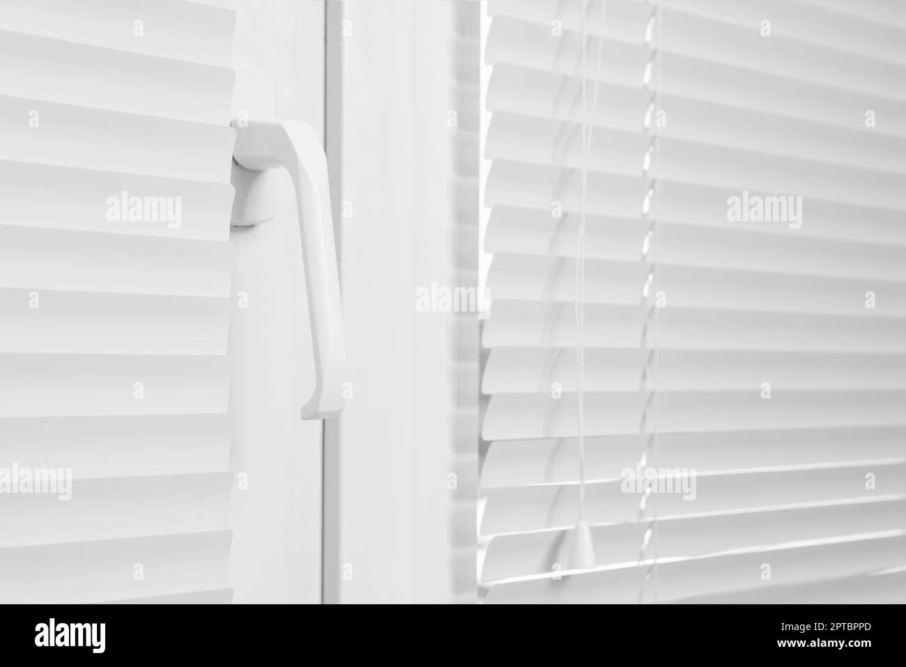 Window with closed white horizontal blinds indoors, closeup Stock Photo ...