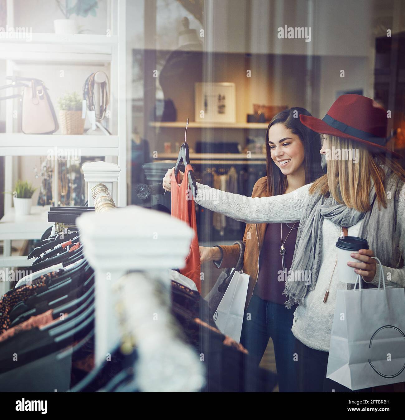What do you think. two best friends out shopping in a clothing store ...