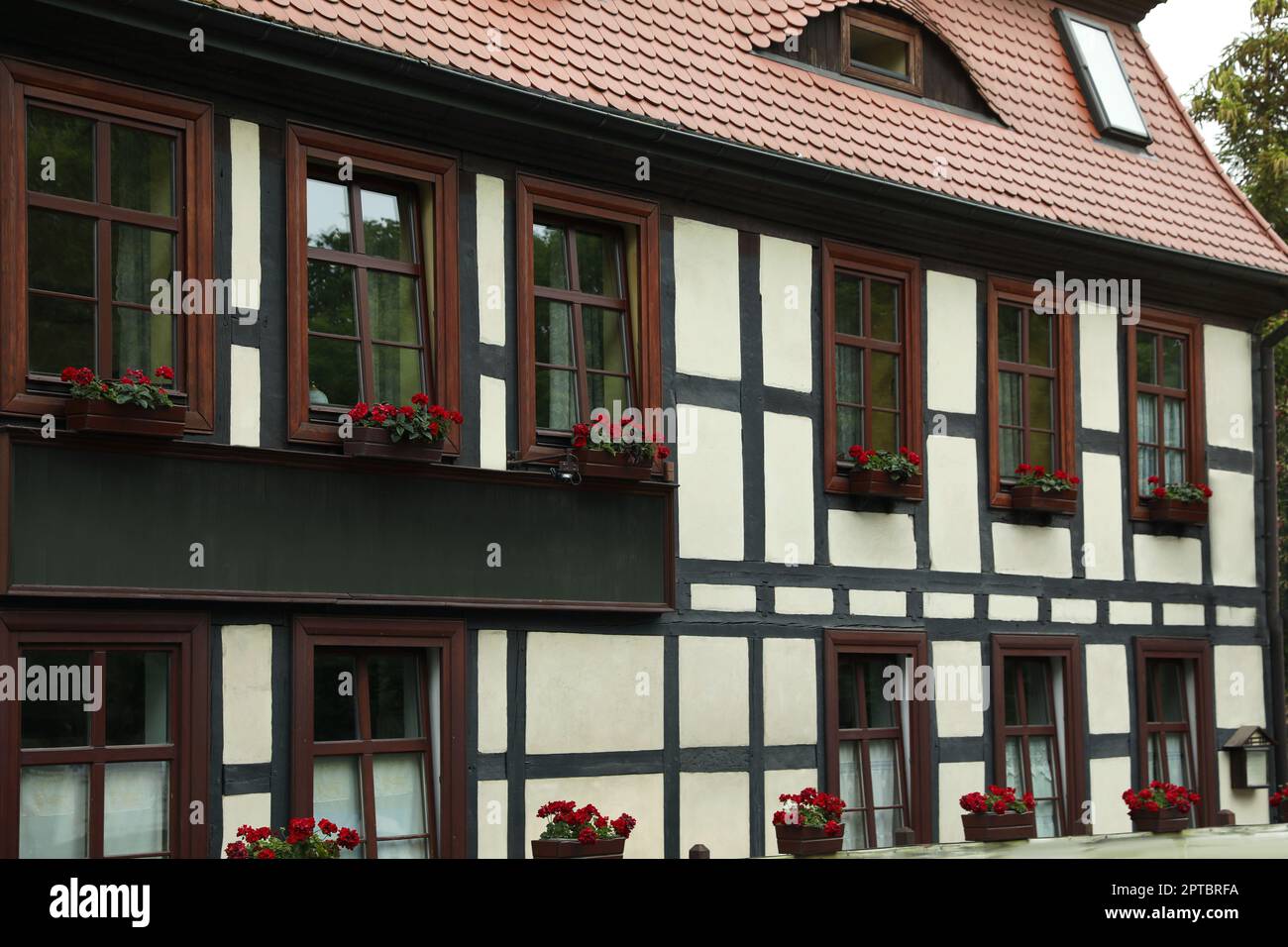 Stylish house with windows and brown roof Stock Photo - Alamy
