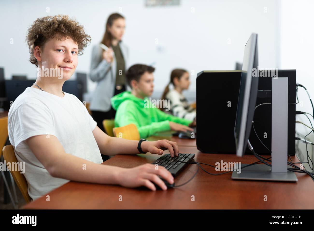Teenager boy using PC during computer science lesson Stock Photo - Alamy