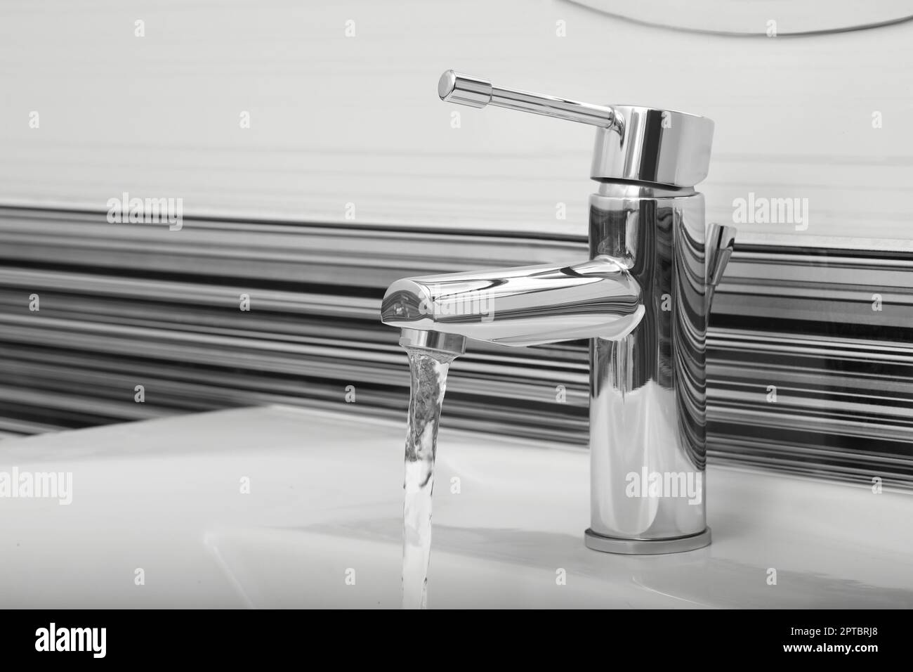 Stream of water flowing from tap in bathroom Stock Photo - Alamy