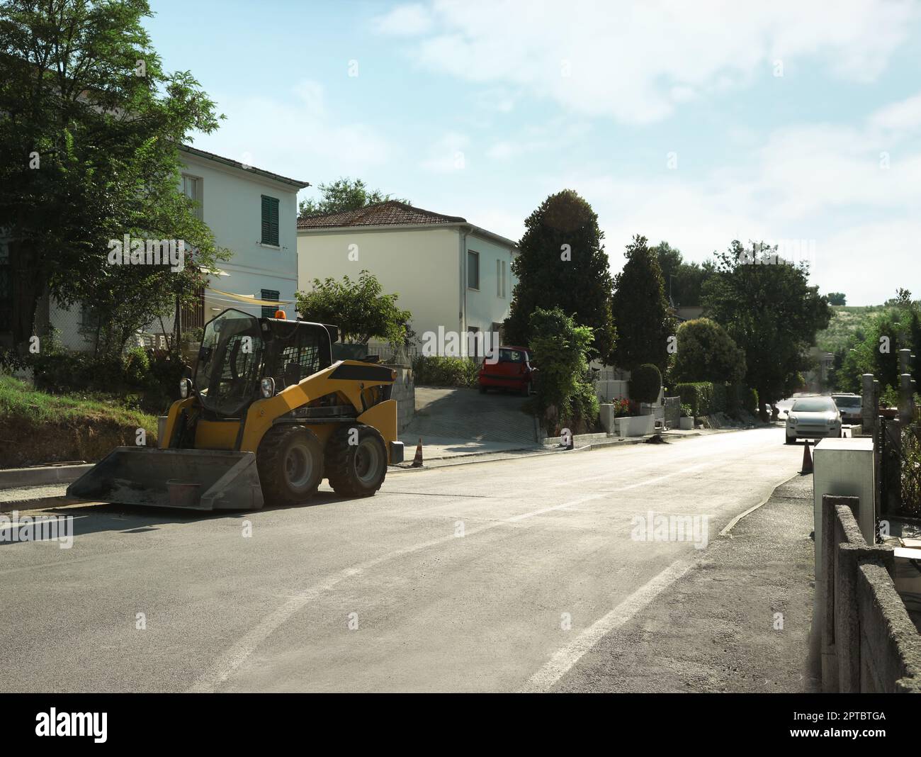 Modern skid loader on city street. Road repair Stock Photo - Alamy