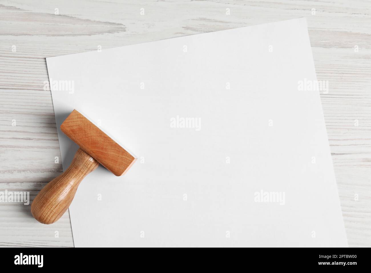 Blank sheet of paper and visa stamp on white wooden table, top view ...