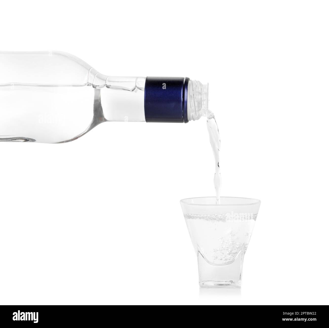 Pouring vodka from bottle in glass on white background Stock Photo - Alamy