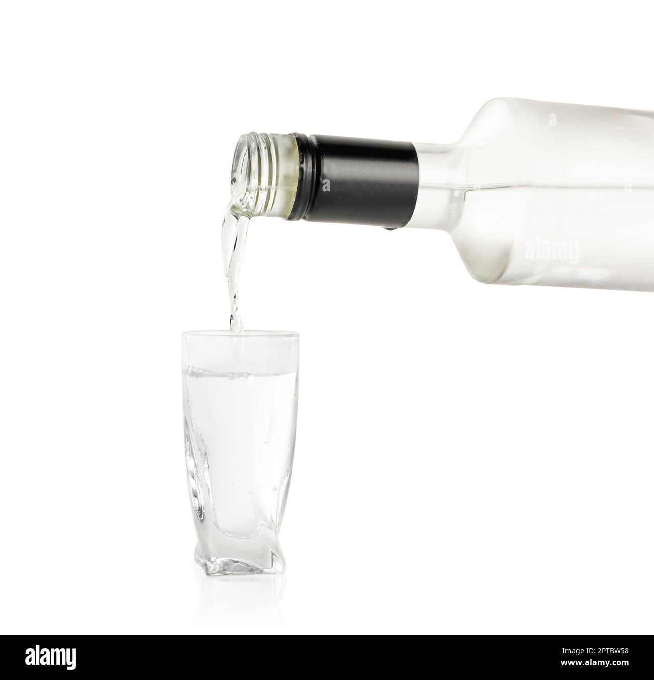 Pouring vodka from bottle in glass on white background Stock Photo - Alamy