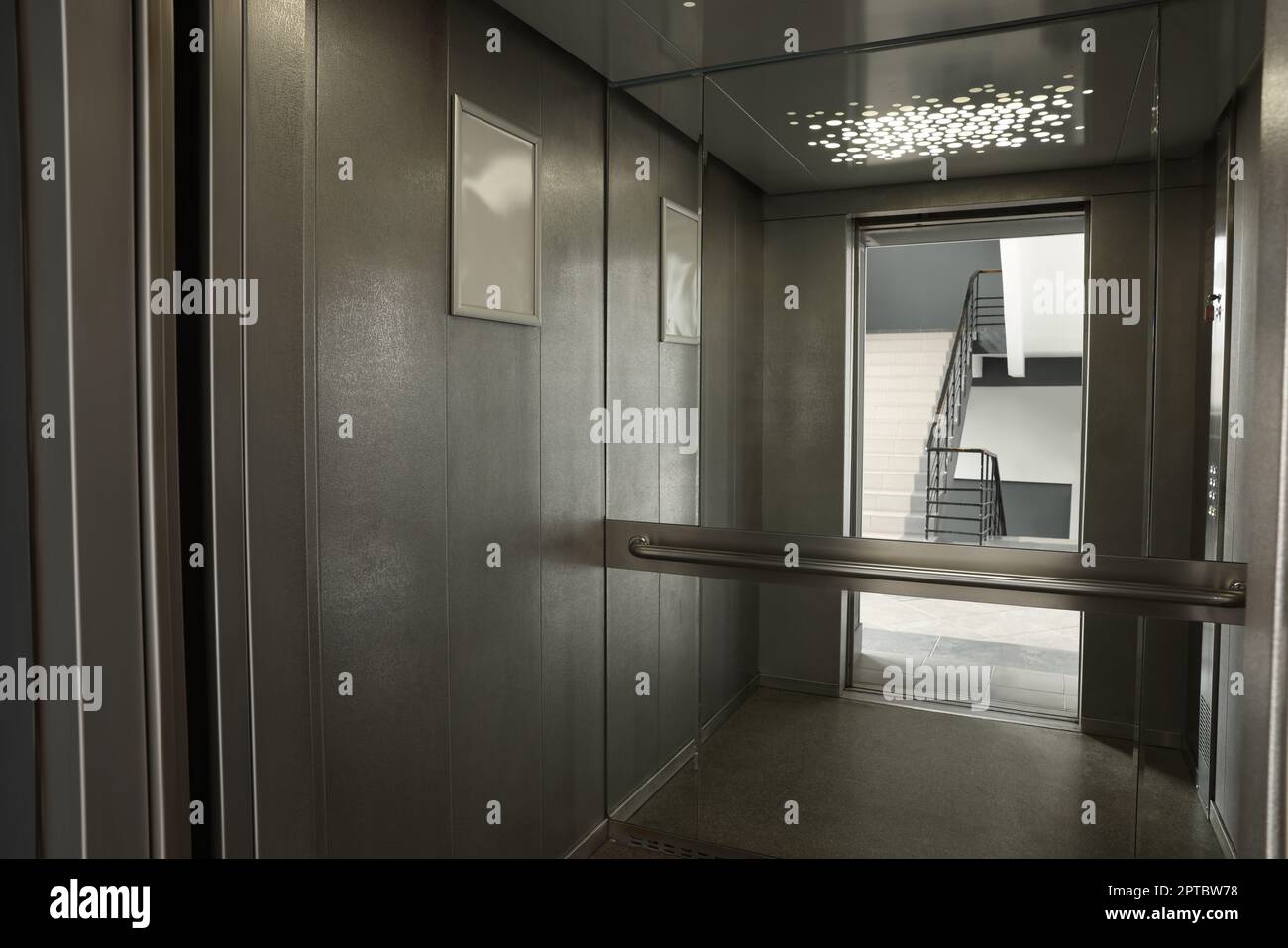Open elevator`s cabin with big mirror indoors Stock Photo - Alamy
