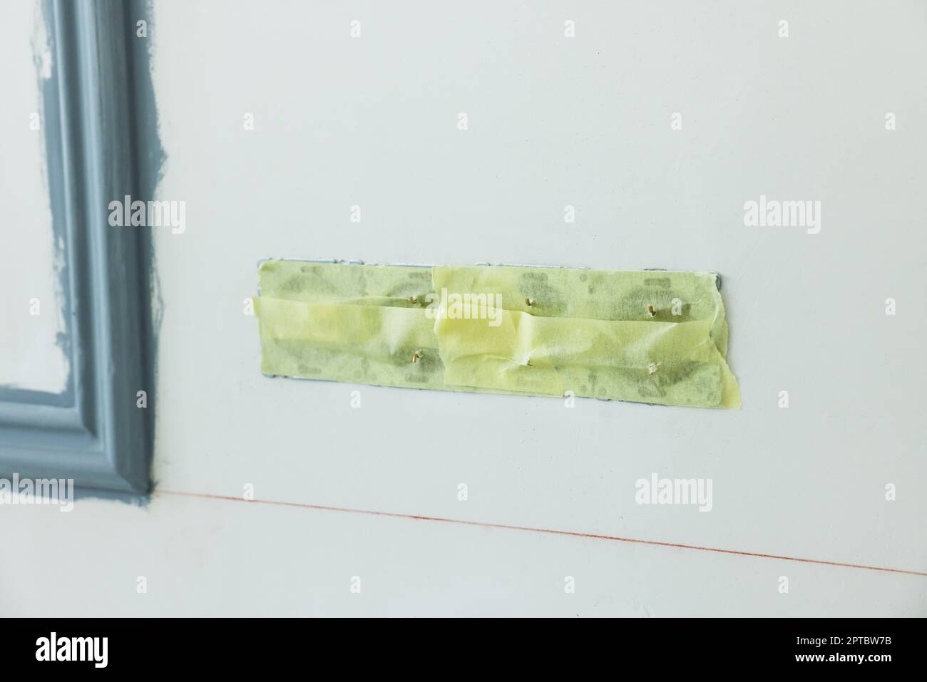 Holes for socket covered with tape on wall Stock Photo - Alamy